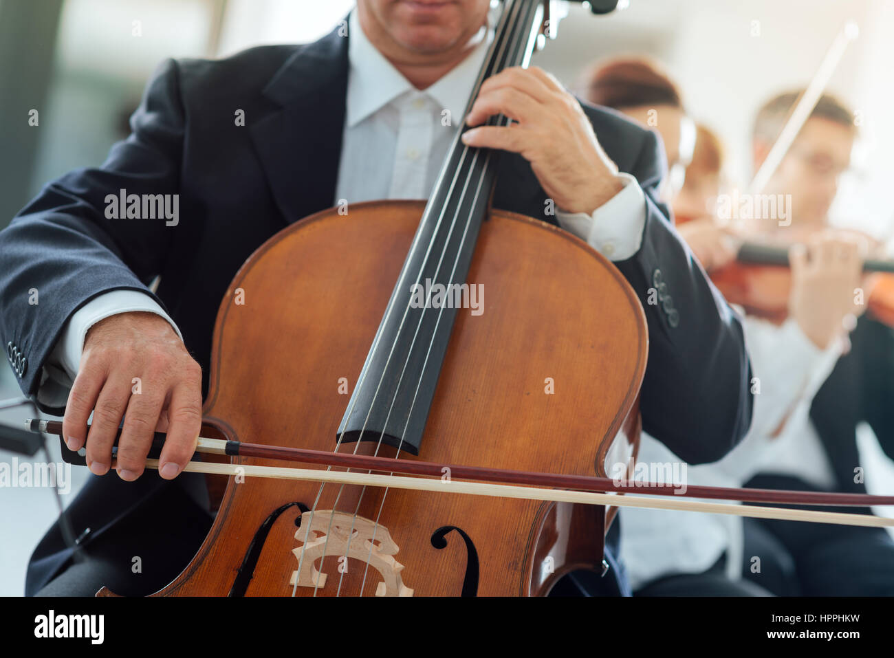 Professional cello player performing with other musicians, classical ...