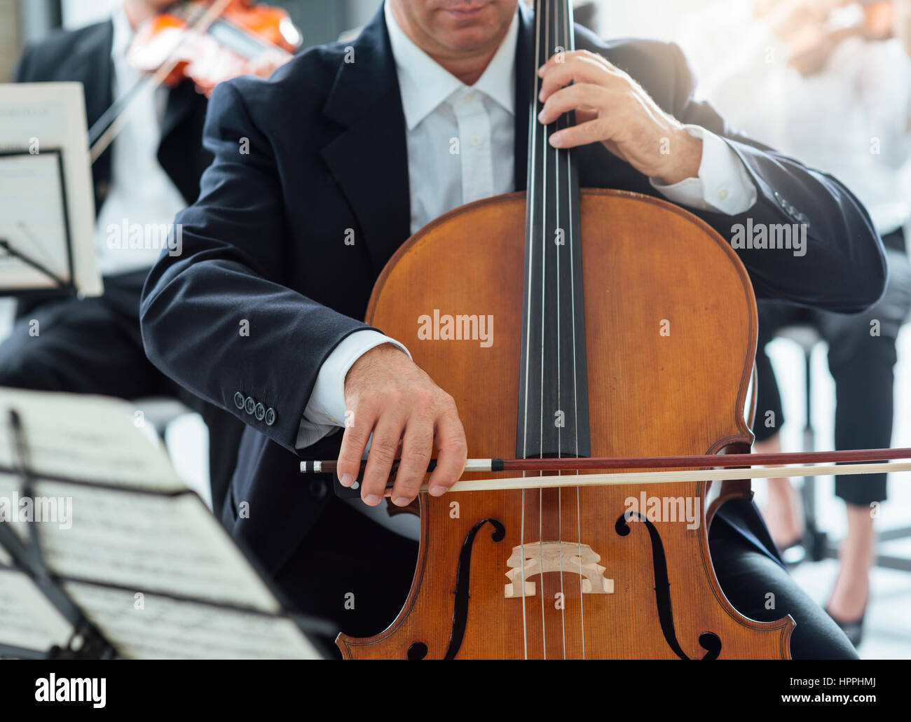 Professional cello player performing with other musicians, classical ...