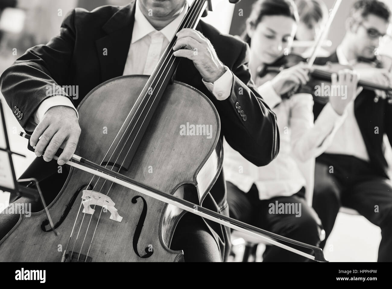 Professional cello player performing with other musicians, classical ...