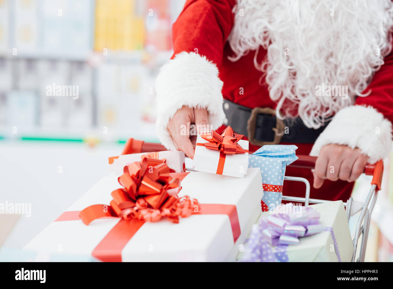 Santa Claus doing Christmas shopping at the supermarket, he is putting ...