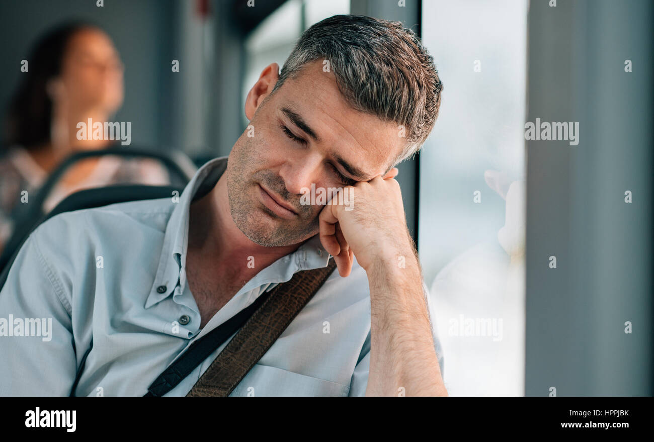 Tired man sleeping on seat hi-res stock photography and images - Alamy