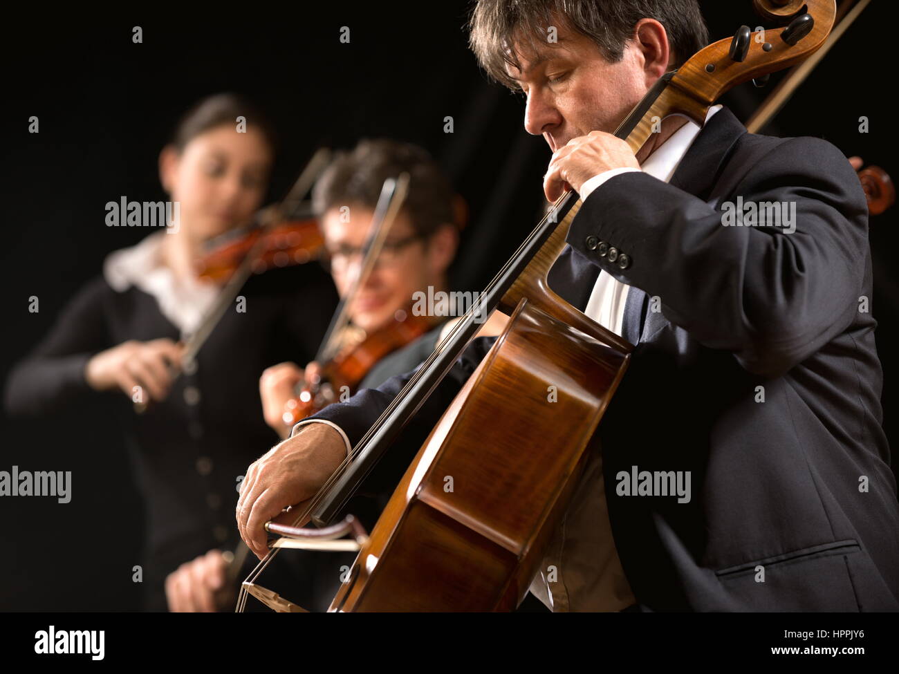 Cello professional player with symphony orchestra performing in concert ...