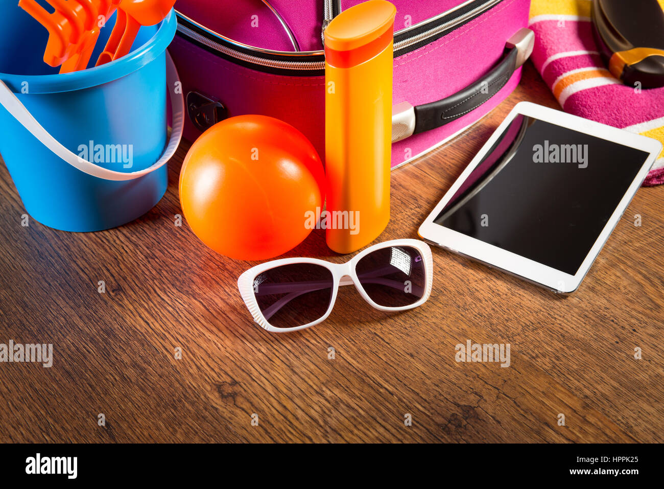 Leaving for vacations on the beach with digital tablet and colorful ...