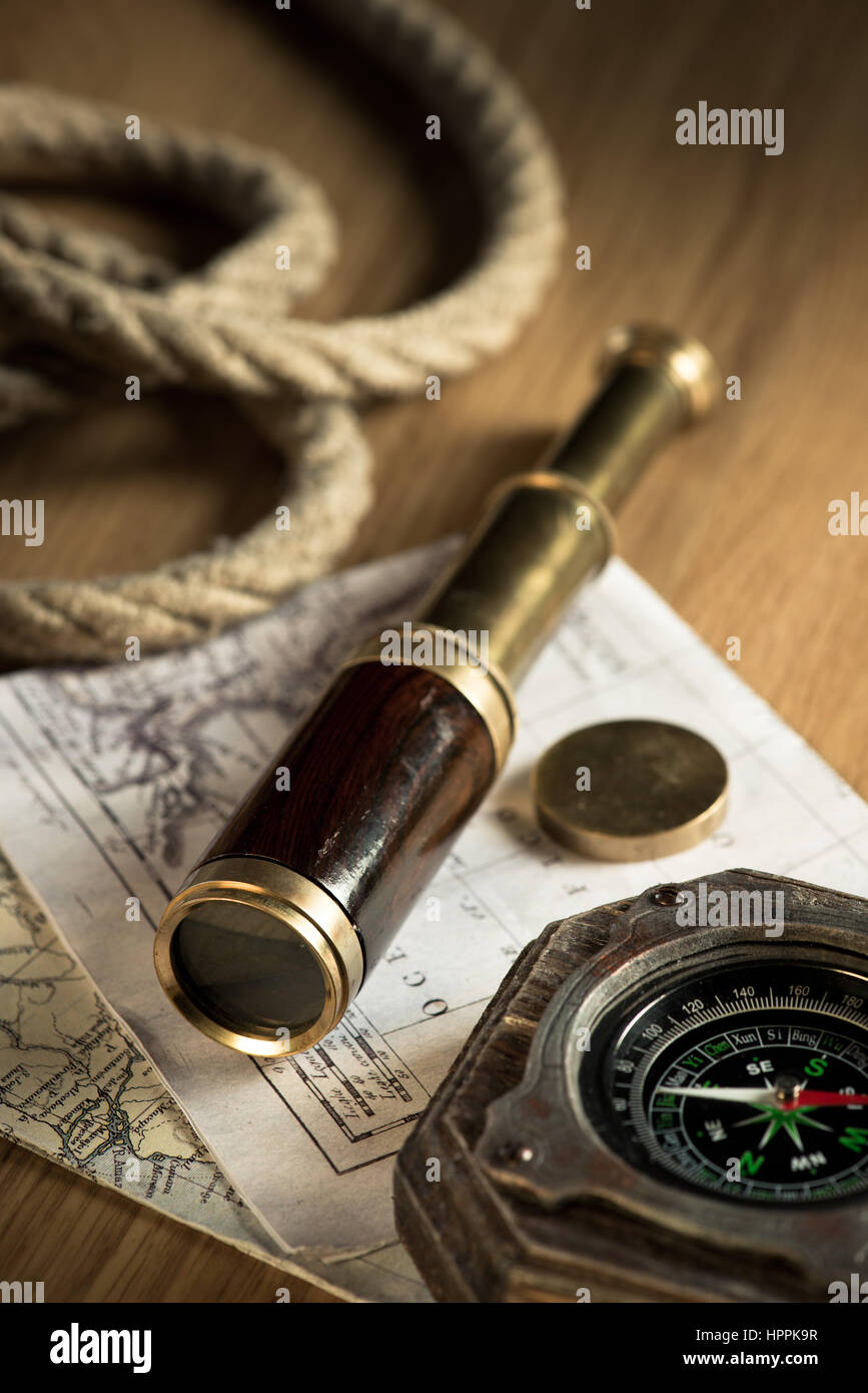 Old map with brass telescope, compass and rope on background Stock ...