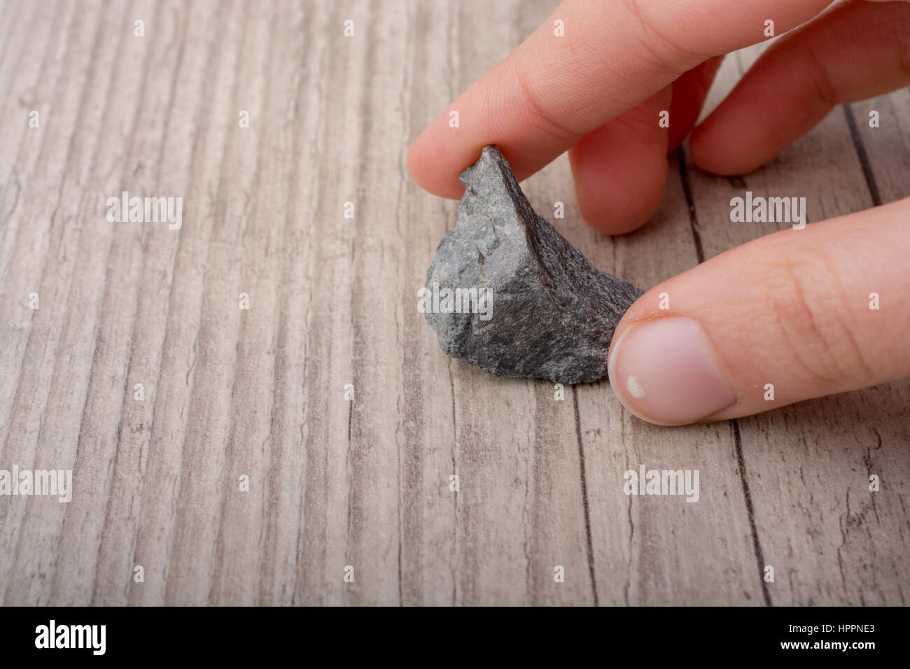 Hand holding little stone in hi-res stock photography and images - Alamy