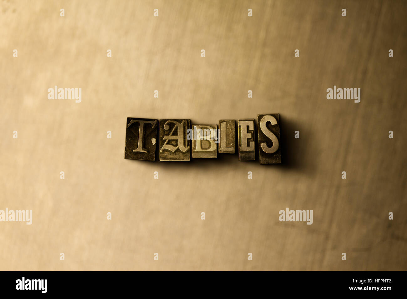 TABLES - close-up of grungy vintage typeset word on metal backdrop ...