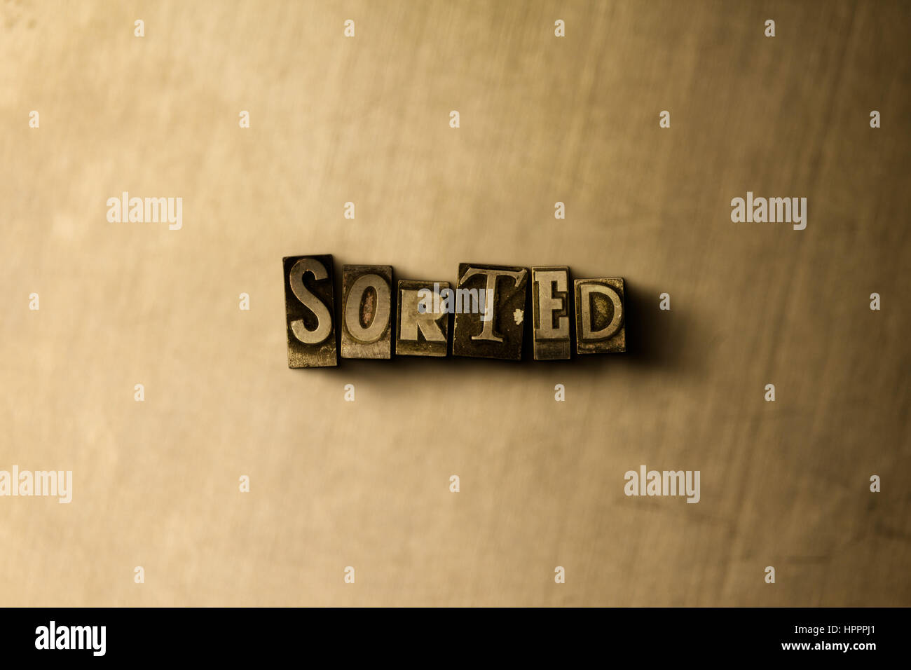 SORTED - close-up of grungy vintage typeset word on metal backdrop ...
