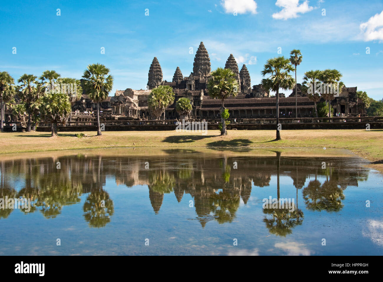 A classic view of Angkor Wat reflected in the water in front of the ...