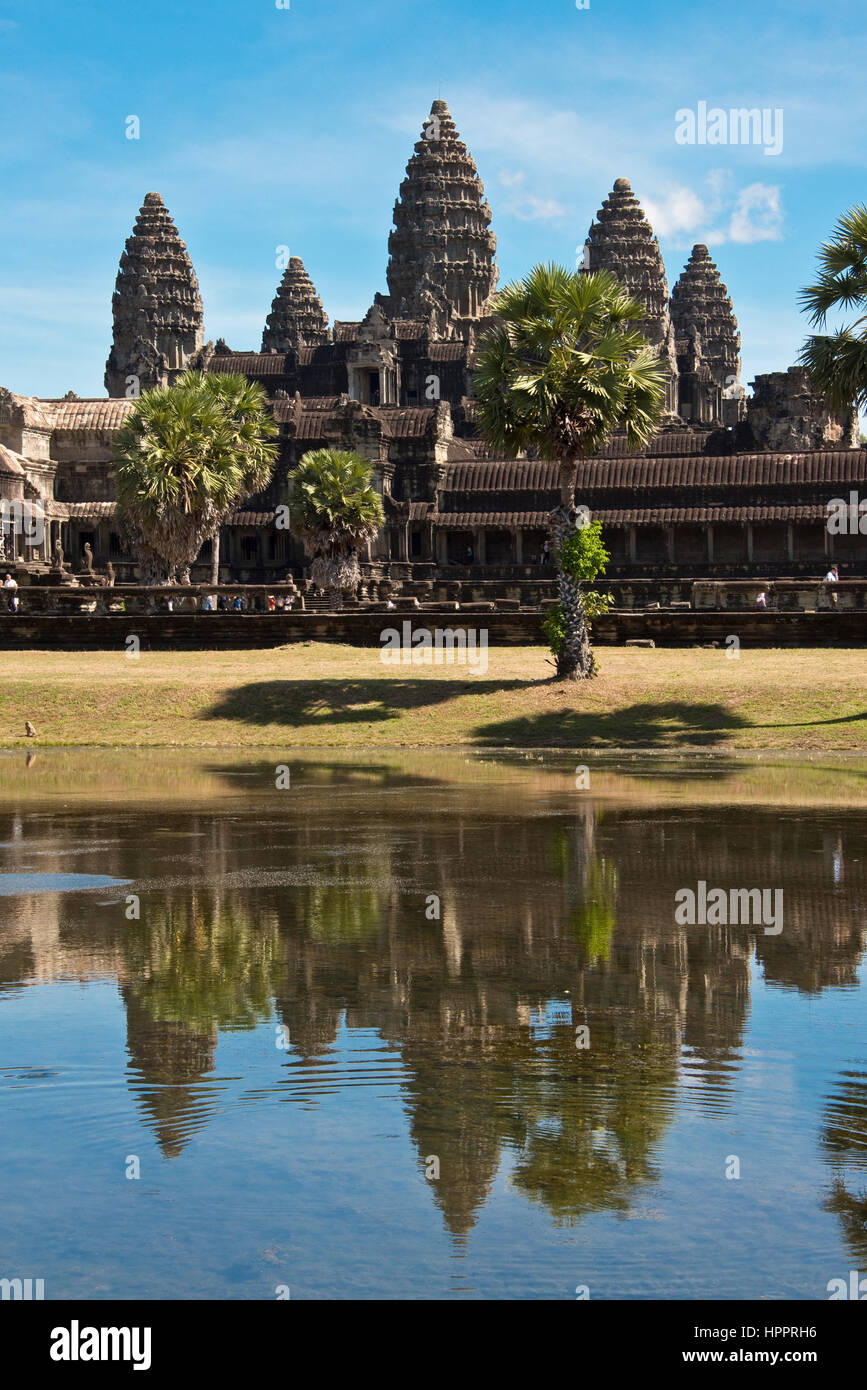 A classic view of Angkor Wat reflected in the water in front of the ...