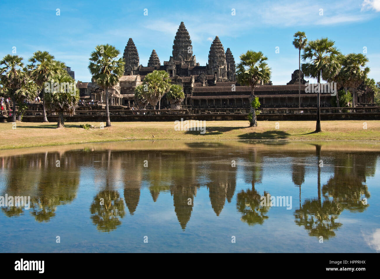 A classic view of Angkor Wat reflected in the water in front of the ...