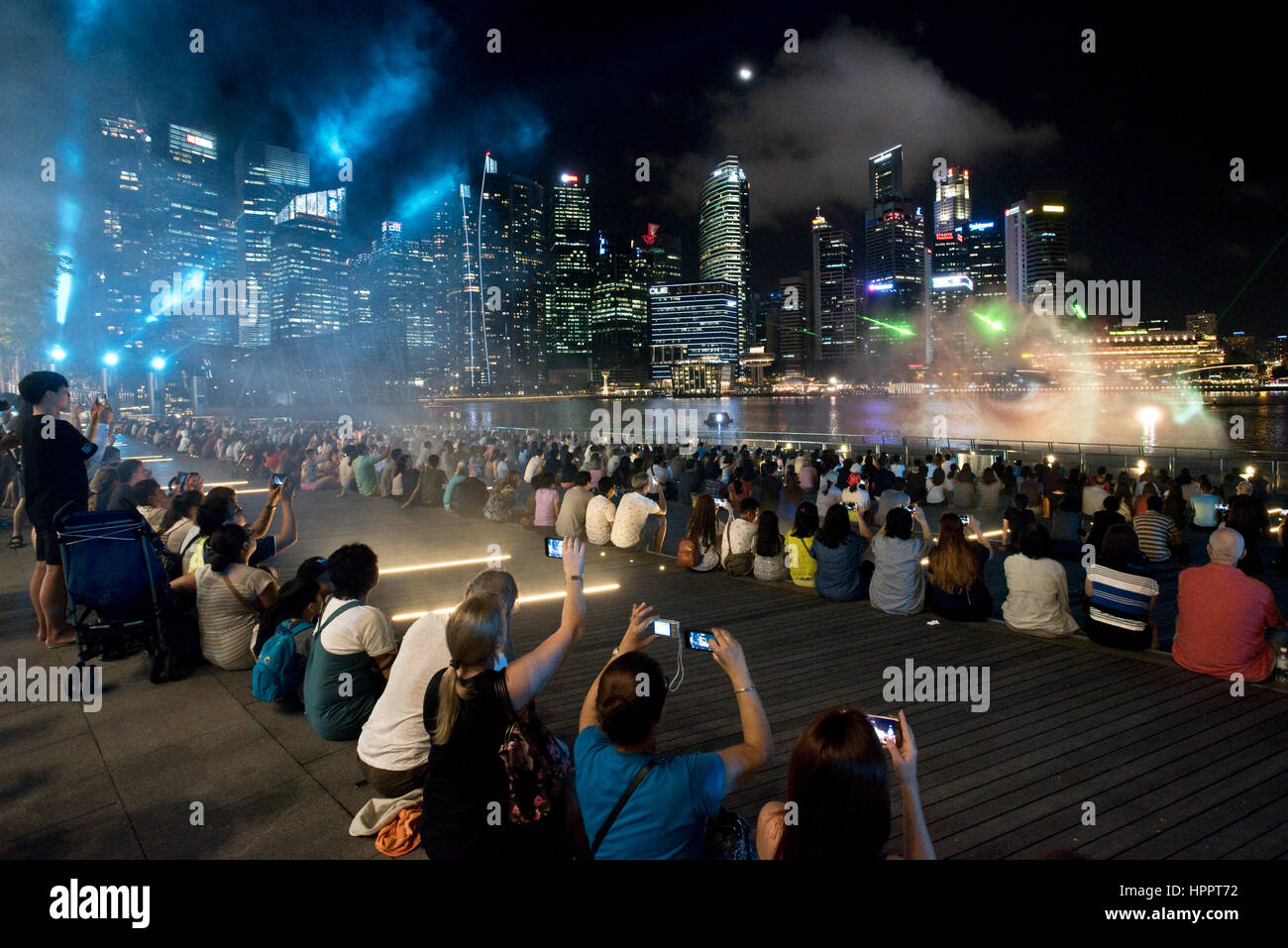 Tourists taking photographs and film of "Wonder Full" - a water, light ...