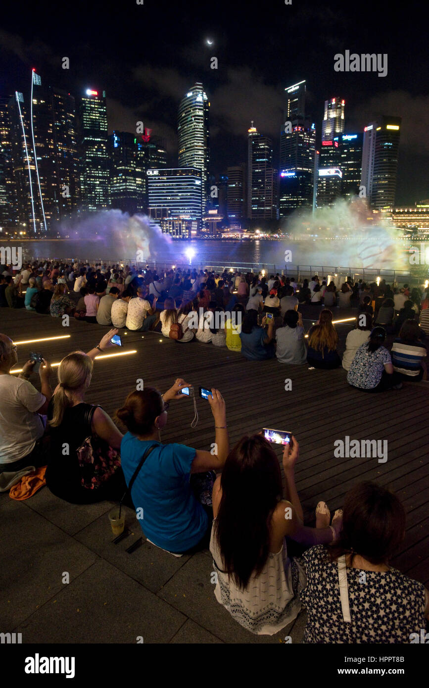 Tourists taking photographs and film of "Wonder Full" - a water, light ...