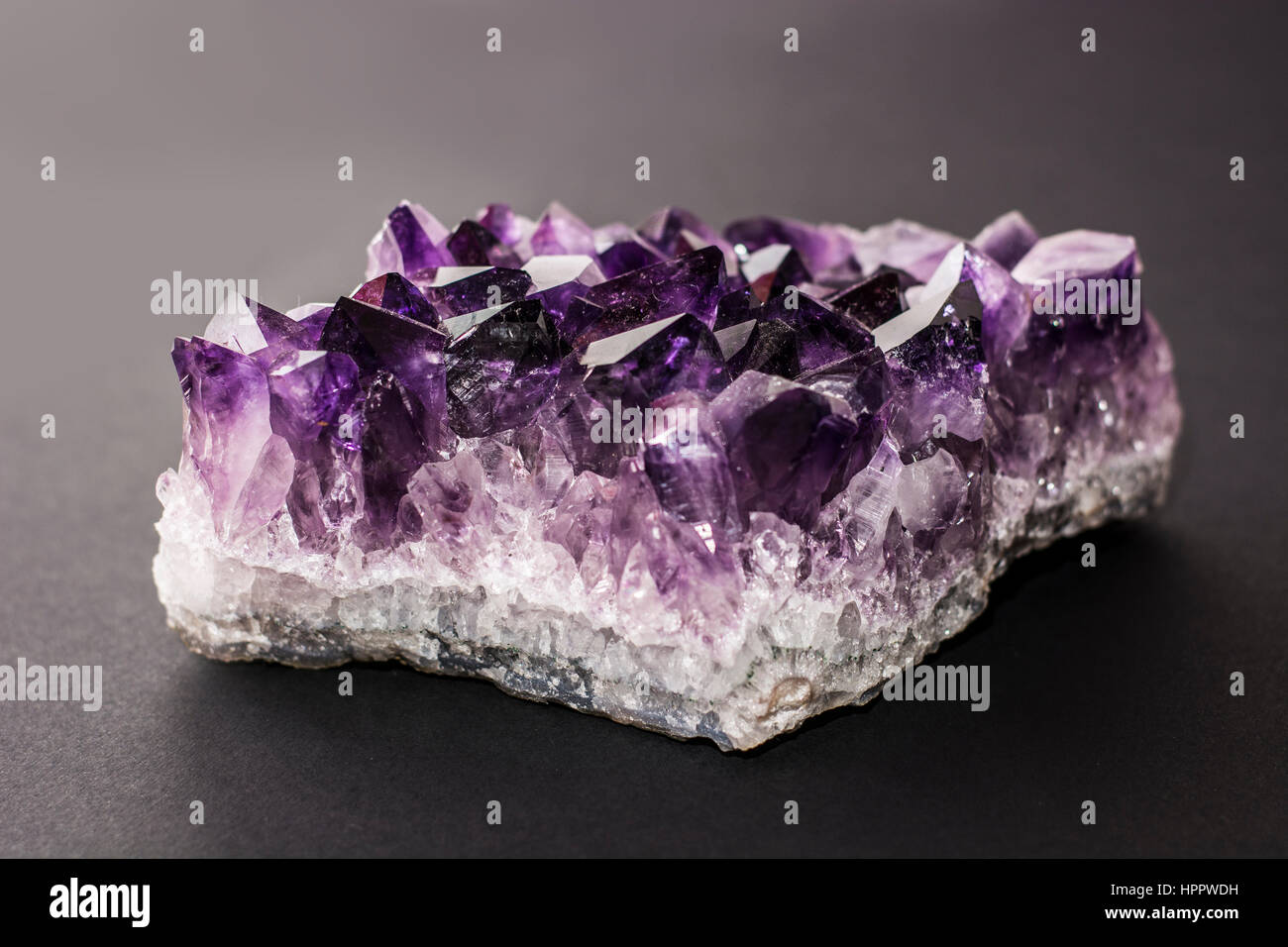 An amethyst stone placed on the white background. Horizontal studio ...