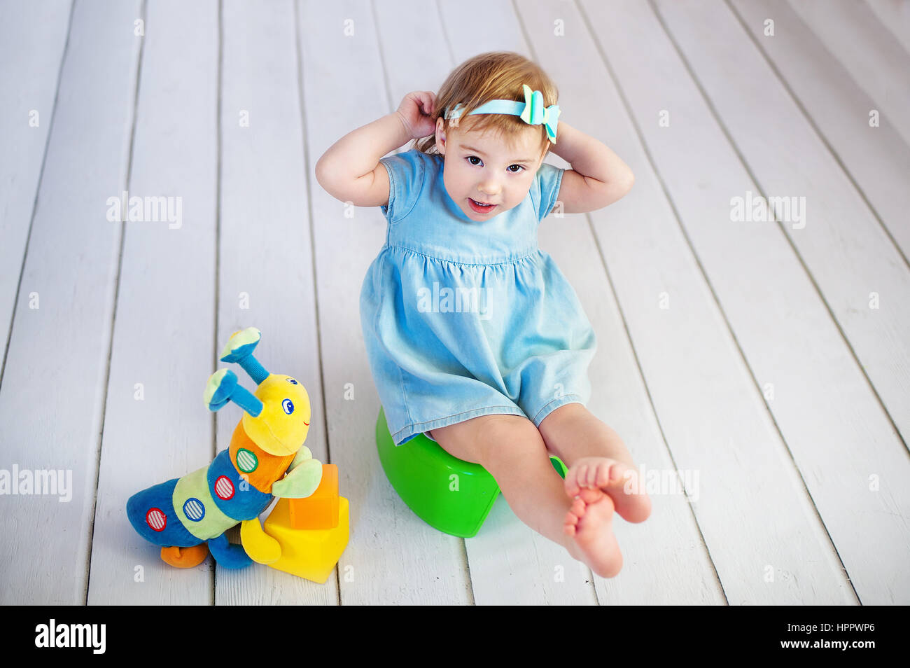 baby on potty play - learning to use toilet Stock Photo - Alamy