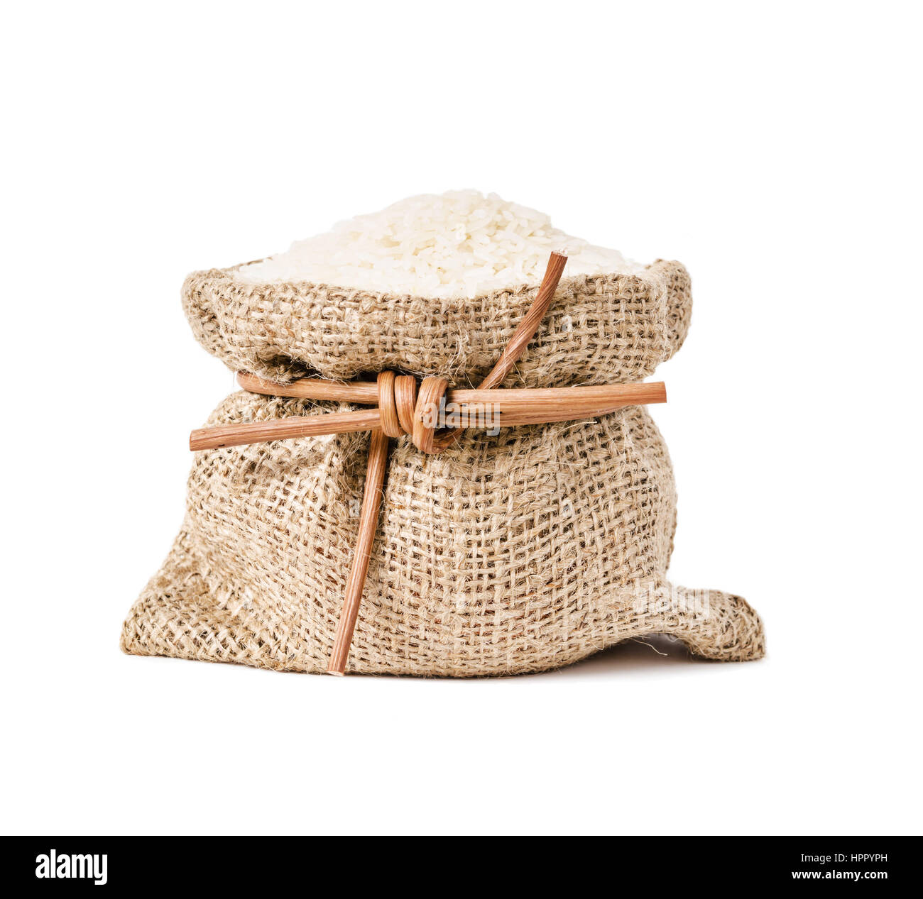 Raw white rice in sack bag isolated on white background Stock Photo - Alamy