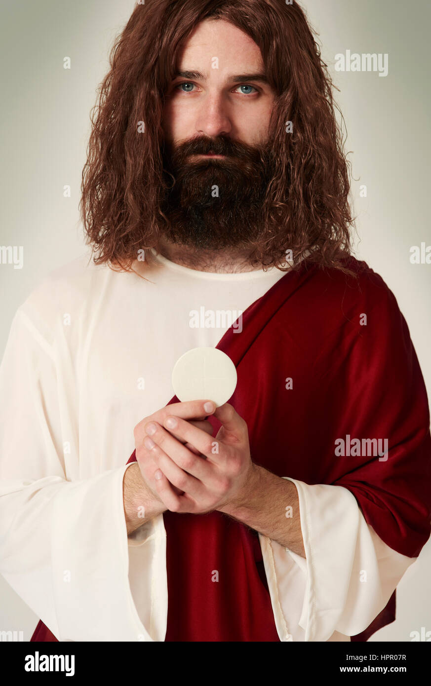 Jesus with the sacred object which is Host Stock Photo - Alamy