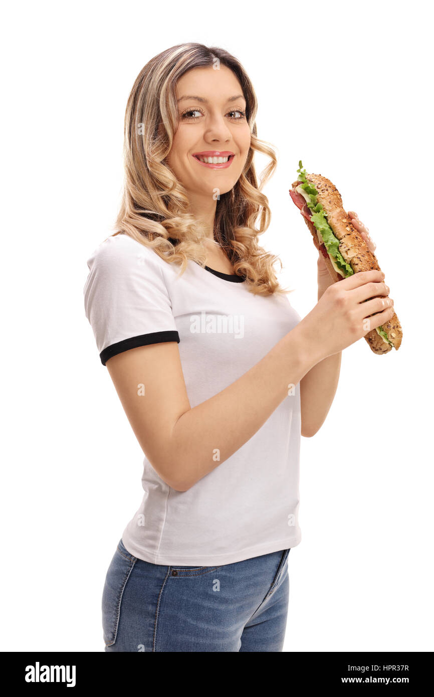 Pretty girl having a sandwich and looking at the camera isolated on ...