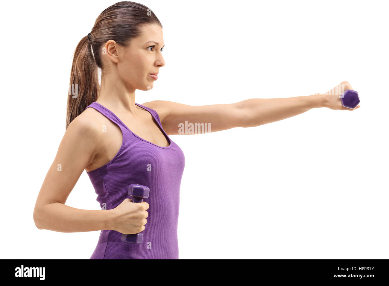 Profile shot of a woman exercising with dumbbells isolated on white ...