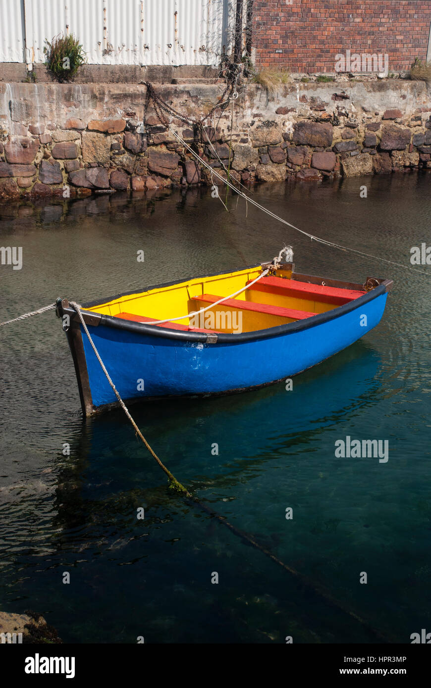 A blue and yellow rowing boat in a harbour in South Africa Stock Photo ...