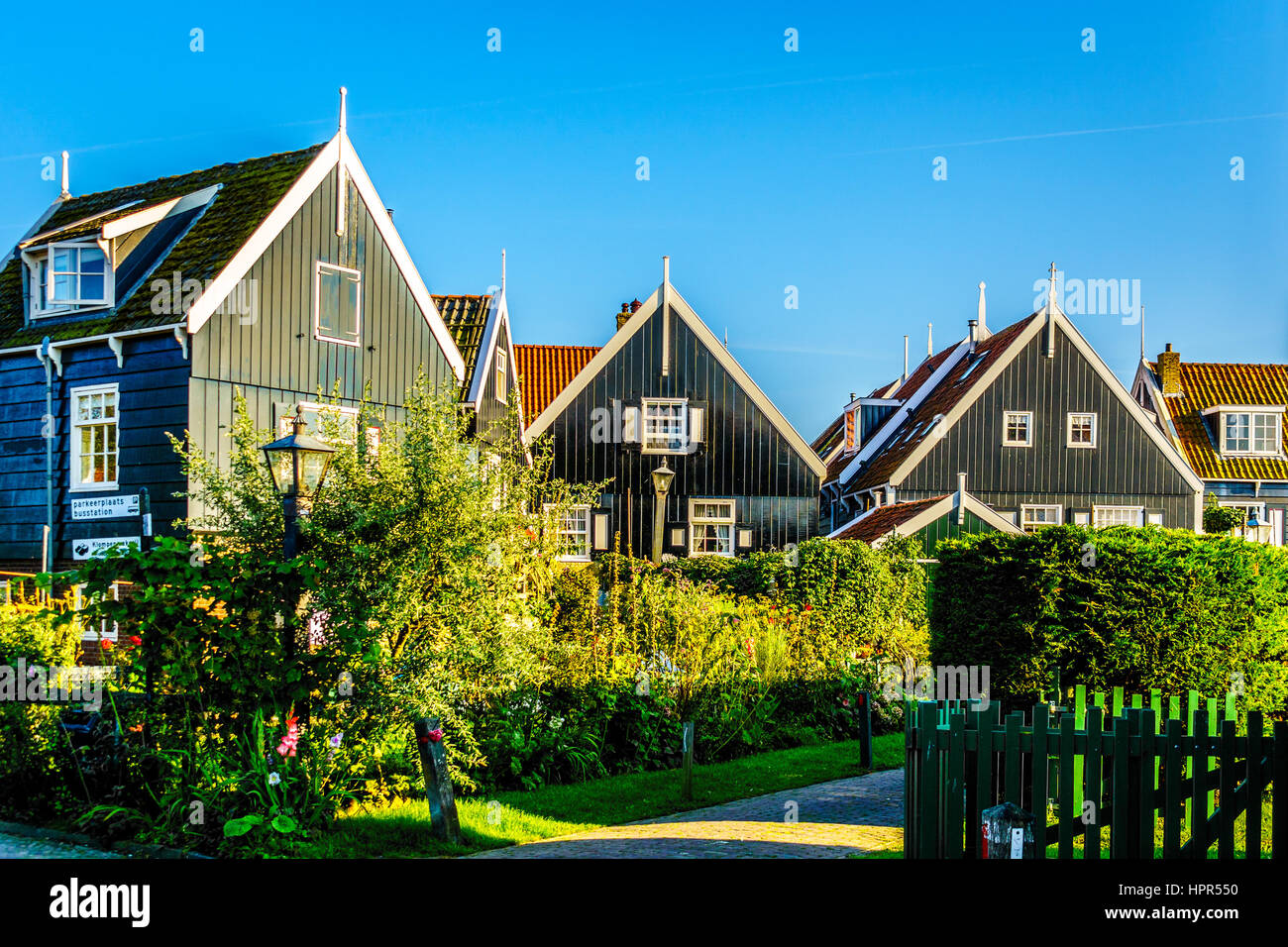 Typical traditional houses with green wall and red tiled roof in the ...