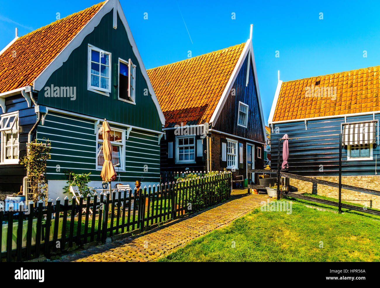 Typical traditional houses with green wall and red tiled roof in the ...