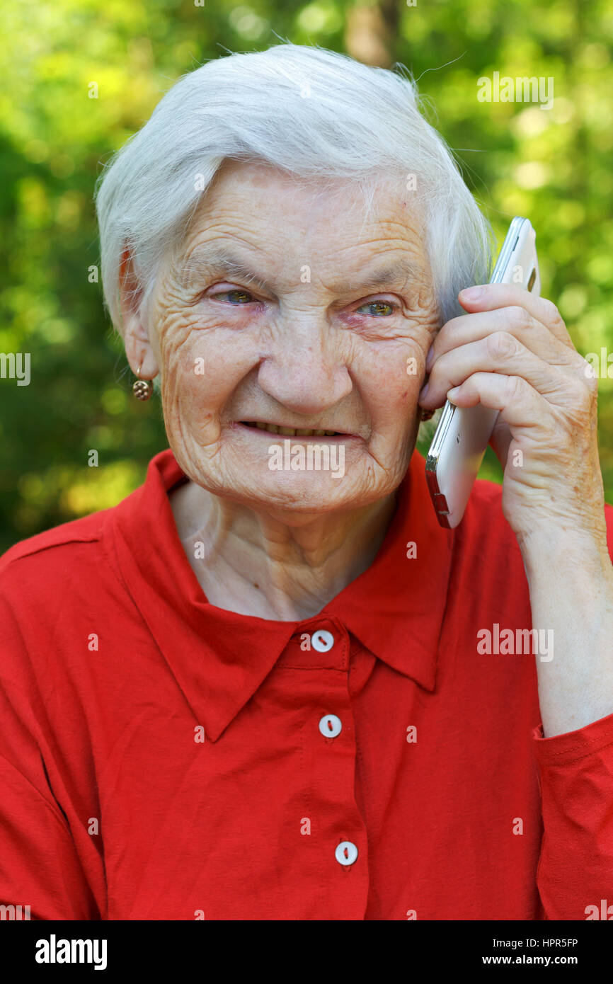 Beautiful elderly woman talking on the smartphone Stock Photo - Alamy