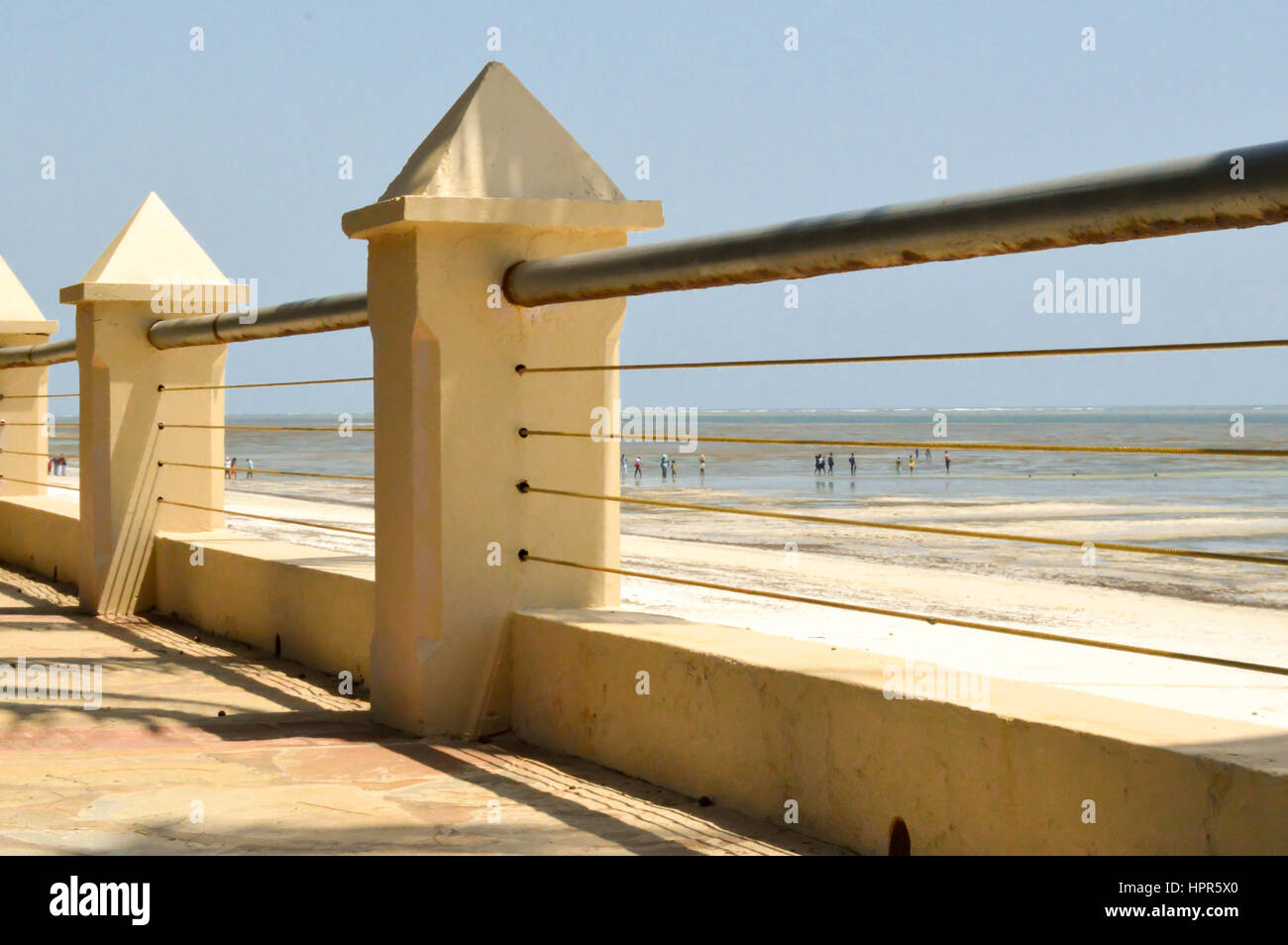Barrier with concrete pylons a metal bar and steel cables separate the ...