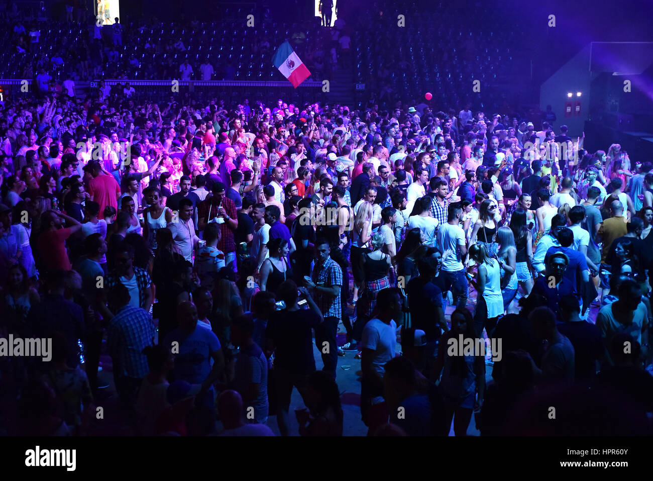 CLUJ-NAPOCA, ROMANIA - AUGUST 7, 2016: Crowd partying in the indoor disco arena during the ...