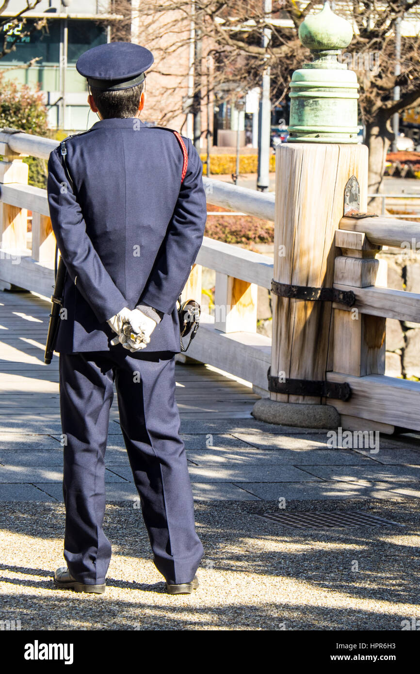 Rear of sentry guard standing on edge of Takebashi Bridge outside of ...