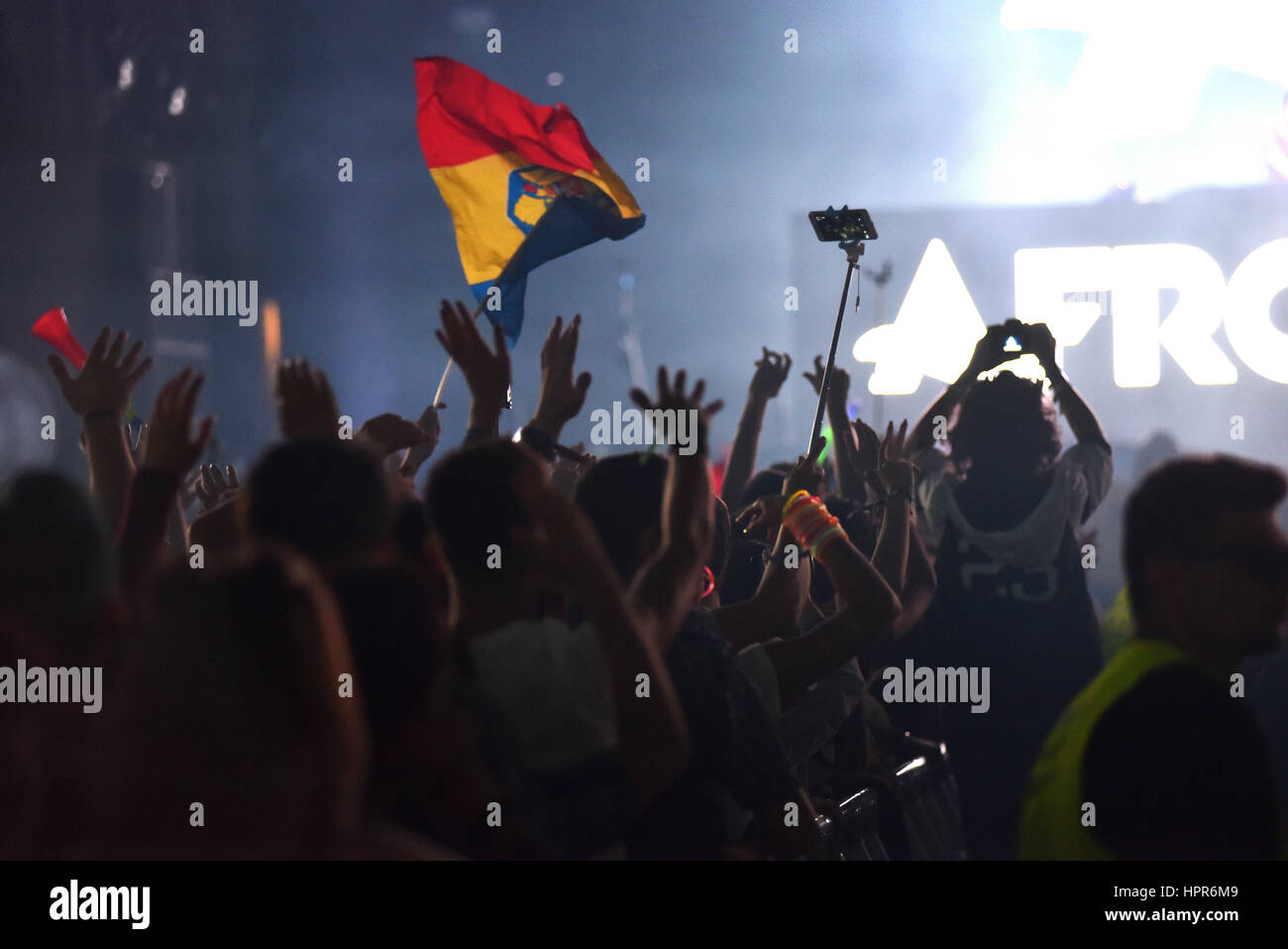 CLUJ-NAPOCA, ROMANIA - AUGUST 8, 2016: Crowd of people partying with raised arms and hands at a ...