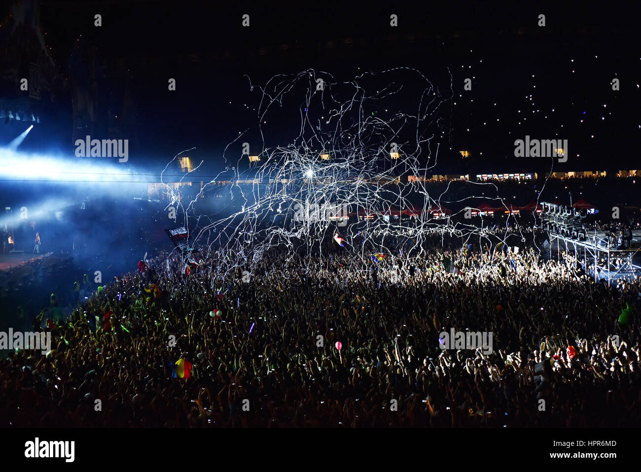 CLUJ-NAPOCA, ROMANIA - AUGUST 7, 2016: Cannons throwing confetti and streamers over partying ...