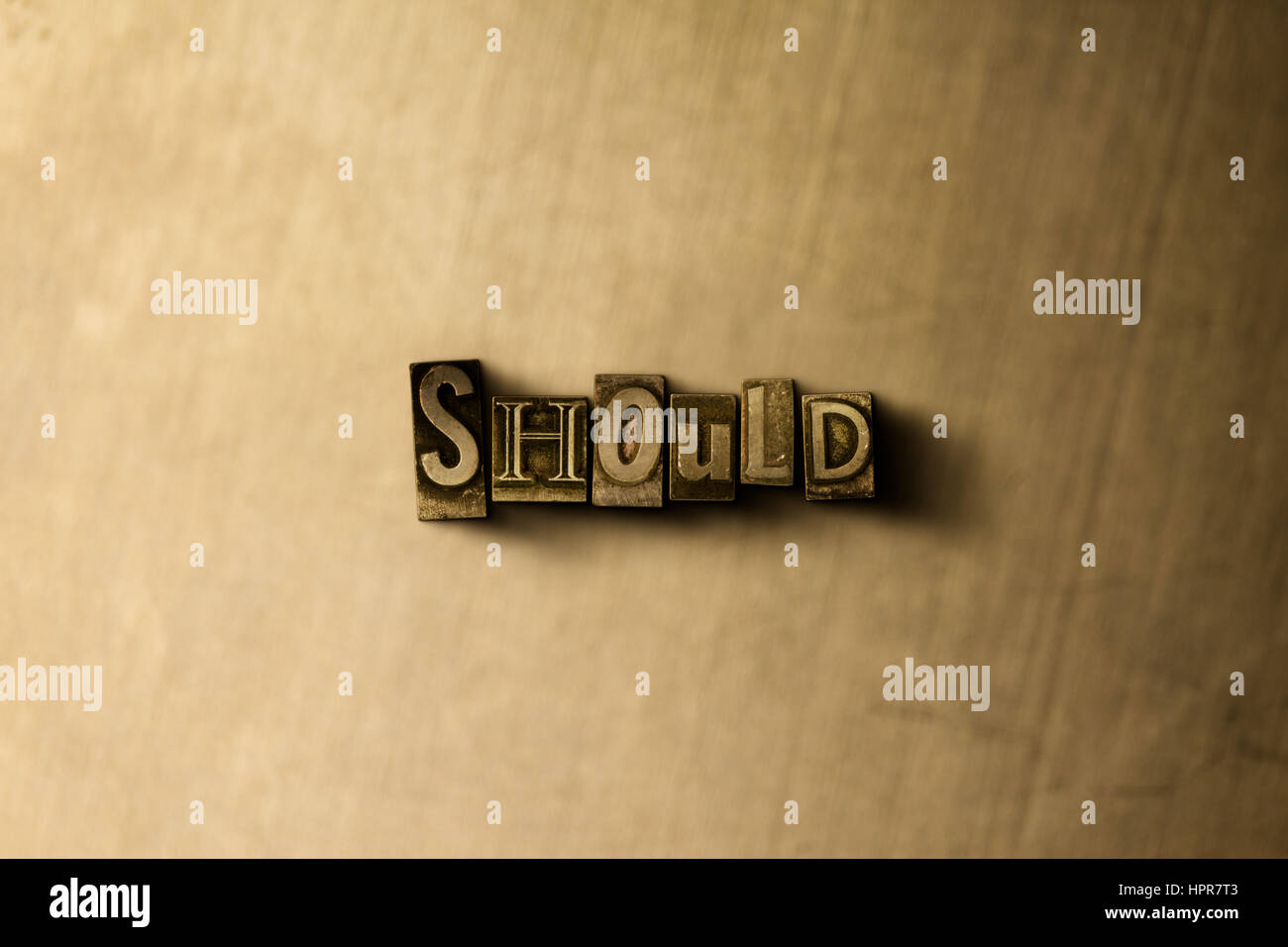 SHOULD - close-up of grungy vintage typeset word on metal backdrop ...