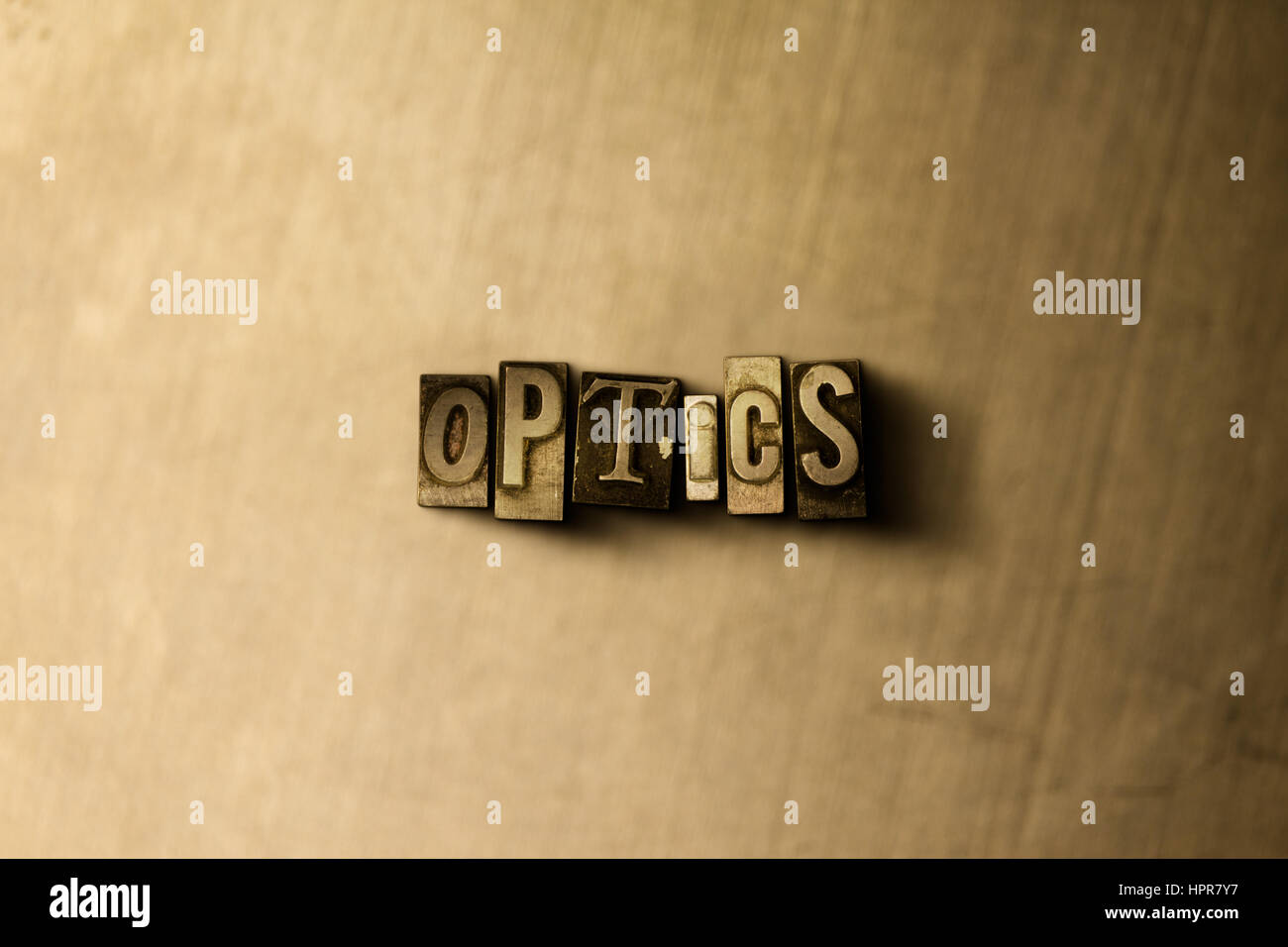 OPTICS - close-up of grungy vintage typeset word on metal backdrop ...