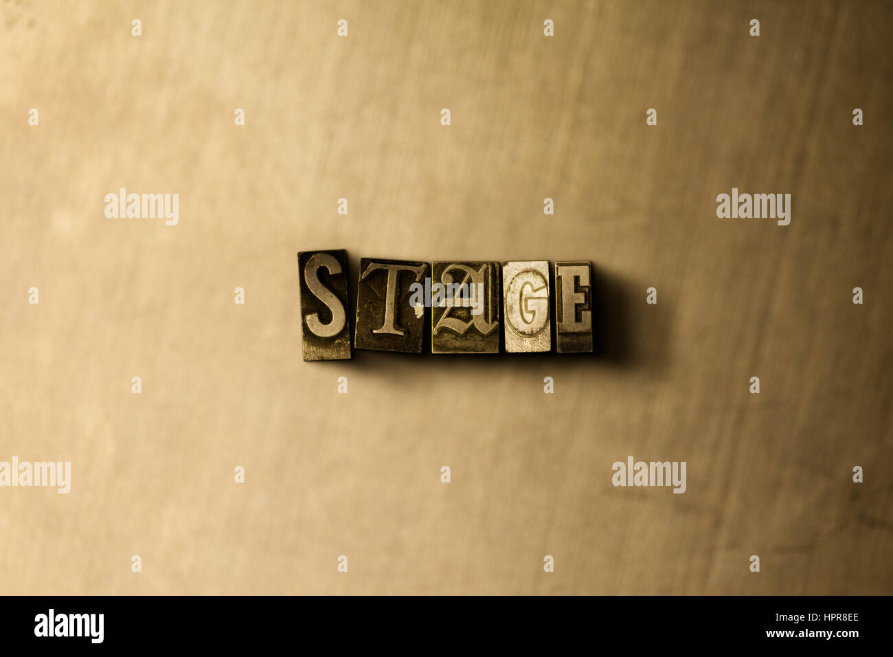 STAGE - close-up of grungy vintage typeset word on metal backdrop ...