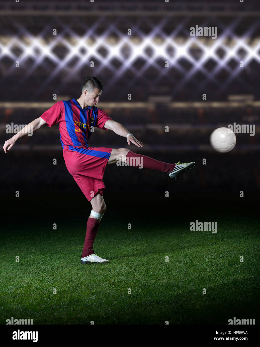 soccer player doing kick with ball on football stadium field Stock ...