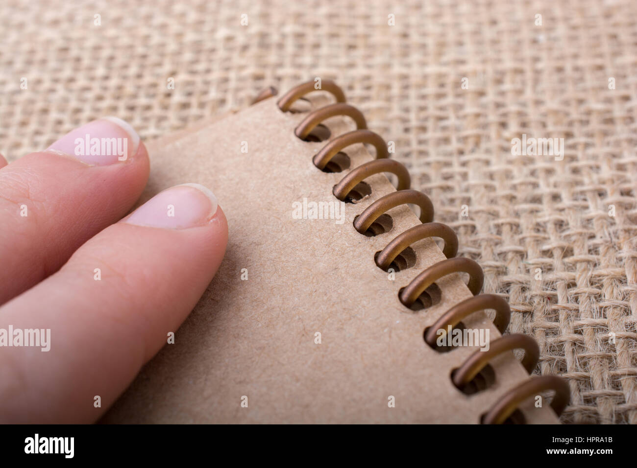 brown color notebook placed on a canvas background Stock Photo - Alamy