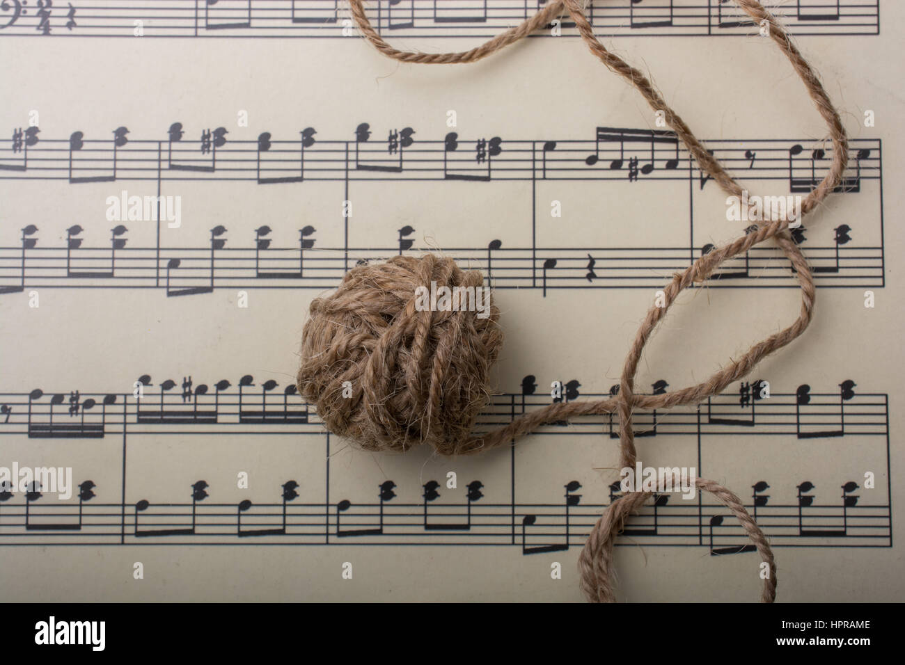 linen thread is placed on paper with musical notes Stock Photo - Alamy