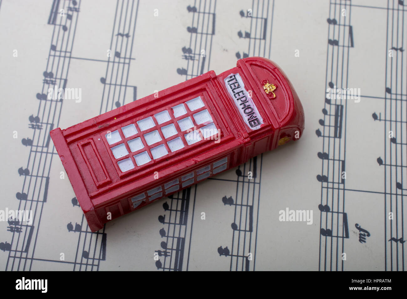 Telephone booth is placed on paper with musical notes Stock Photo - Alamy