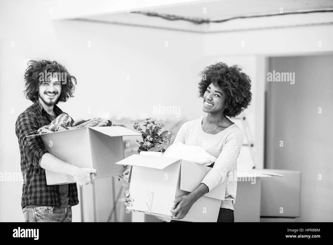 Unpacking boxes at home Black and White Stock Photos & Images - Alamy