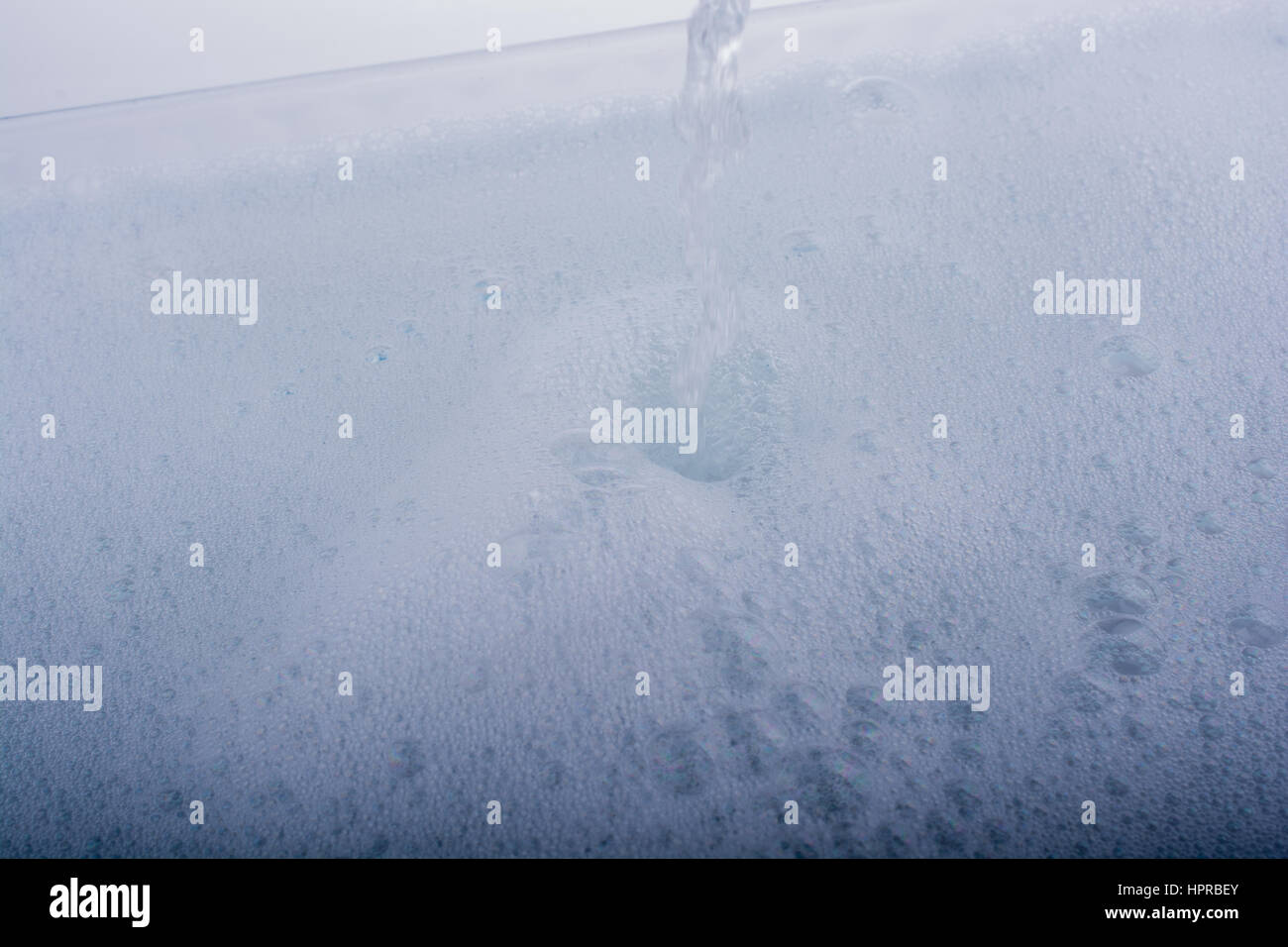 Pure water covered with foam of shampoo Stock Photo - Alamy