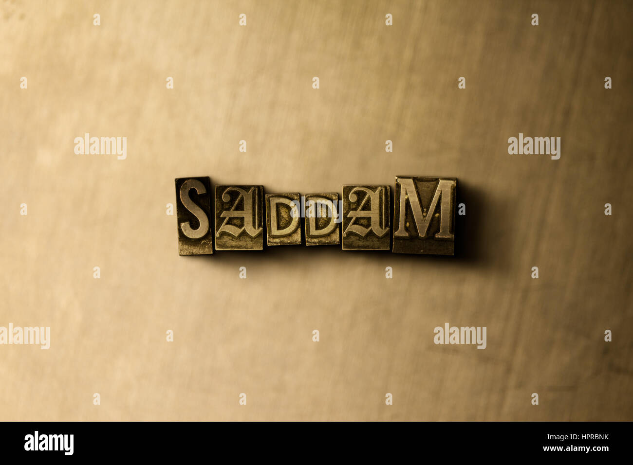 SADDAM - close-up of grungy vintage typeset word on metal backdrop ...