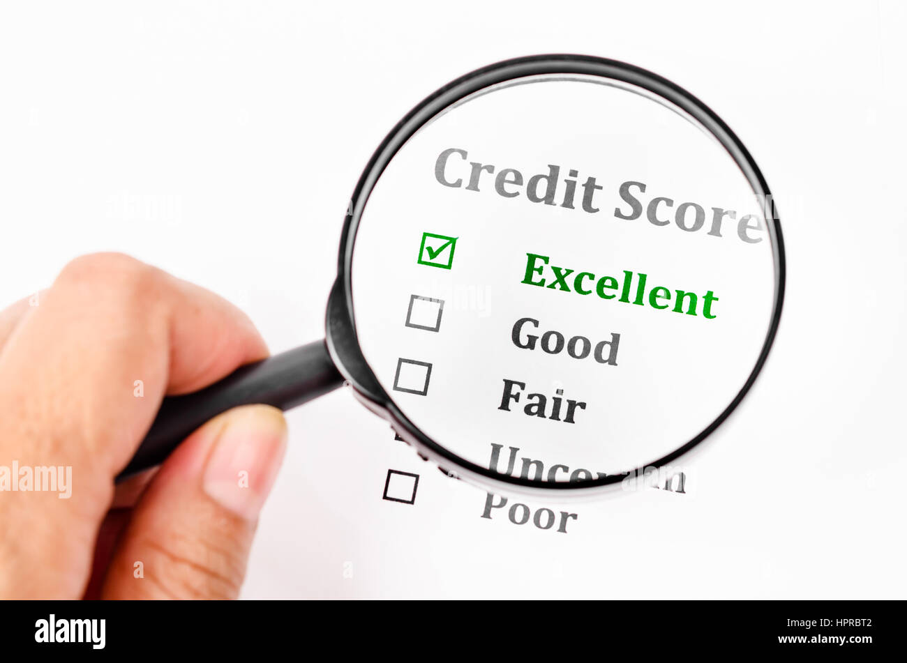 Credit score form with hand holding magnifier glass Stock Photo - Alamy