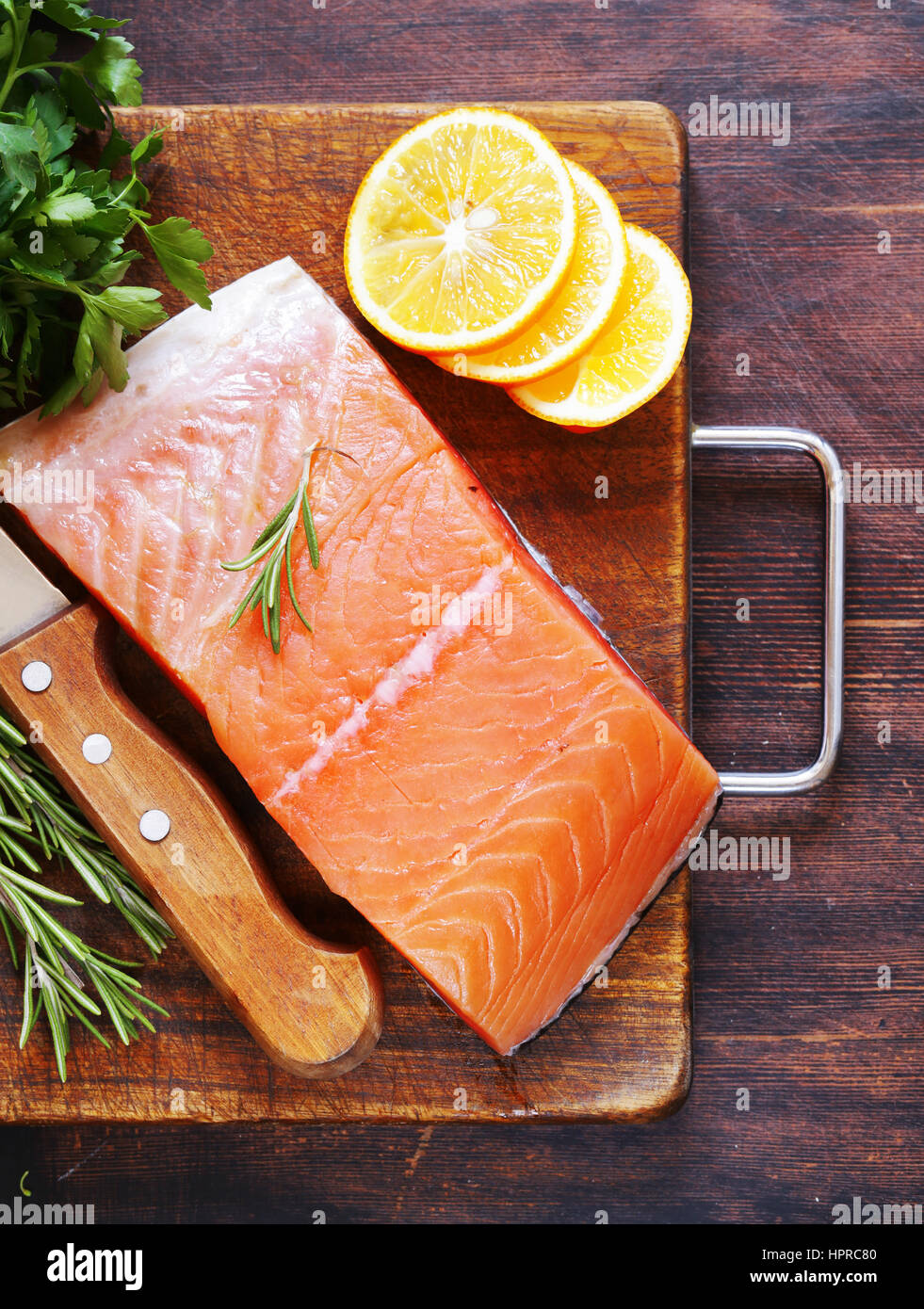 fresh red fish fillet of salmon with lemon and herbs Stock Photo - Alamy