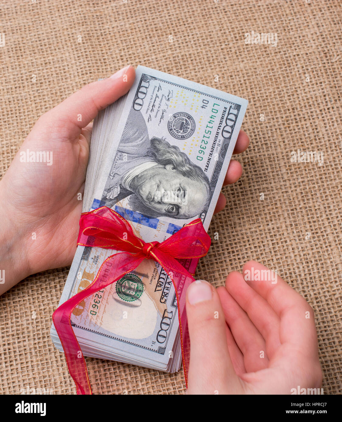 Banknote bundle of US dollar tied with colorful a ribbon Stock Photo ...
