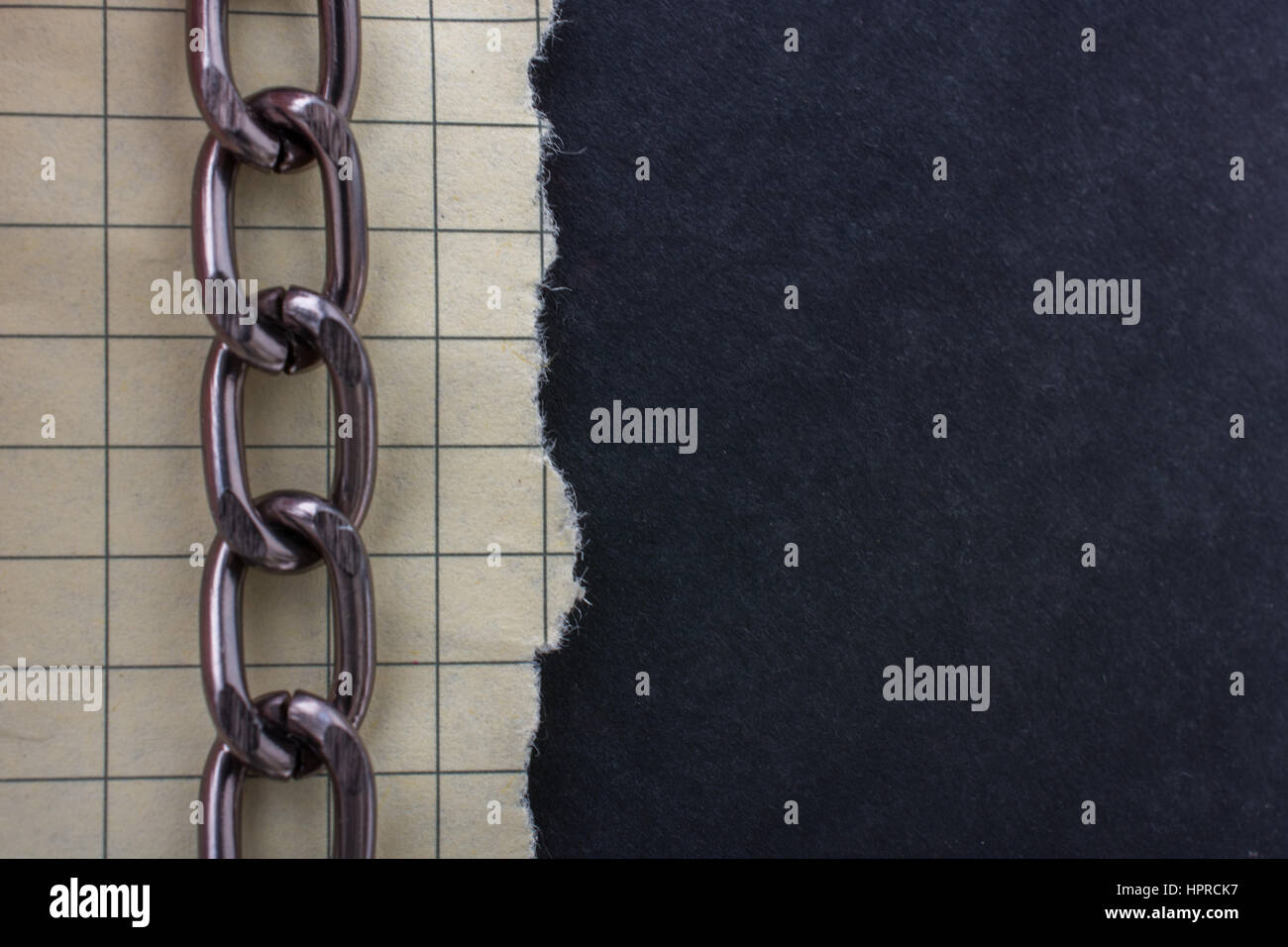 Chain and torn paper on a dark background Stock Photo - Alamy