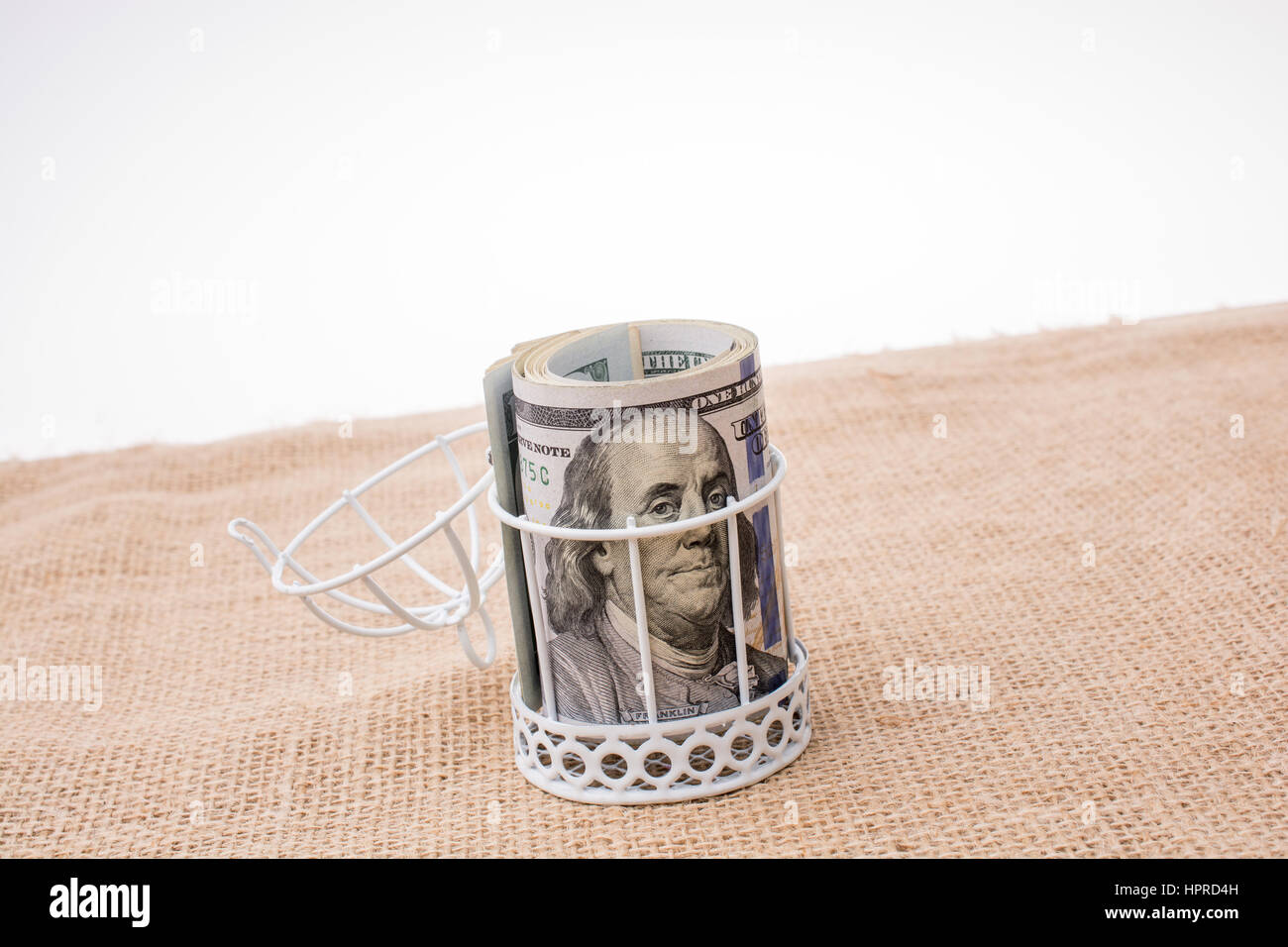 Banknote bundle of US dollar placed in a birds cage Stock Photo - Alamy