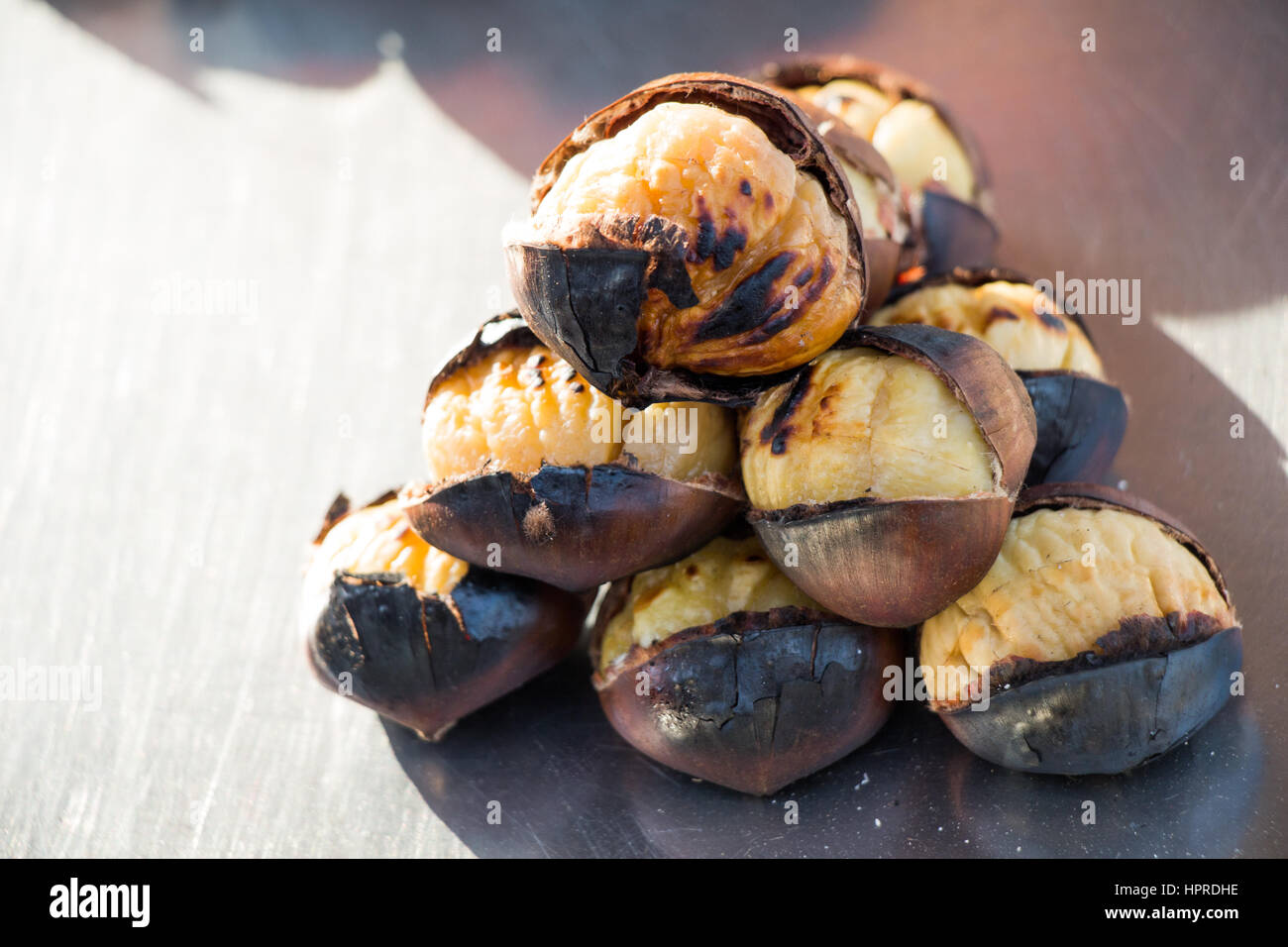 Organic brown chestnuts roasted over a hot fire Stock Photo - Alamy