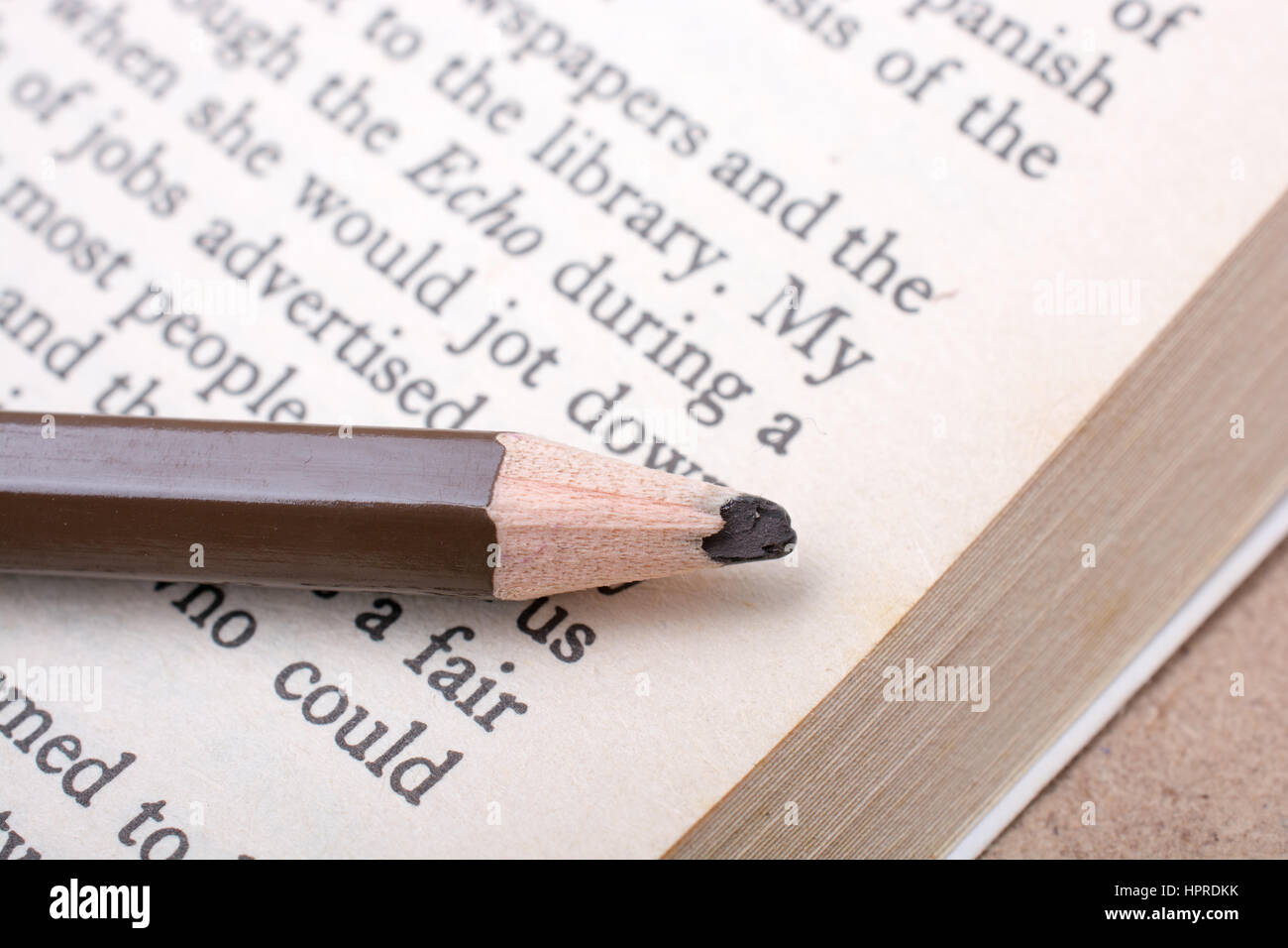 Color pencil placed on the page of a book with text Stock Photo - Alamy