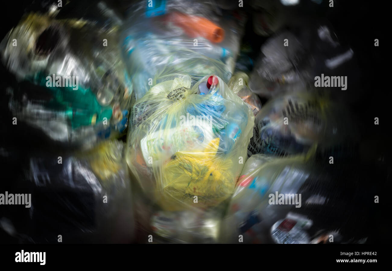 Close Up of garbage and waste in transparent bags. Radial blur effect ...