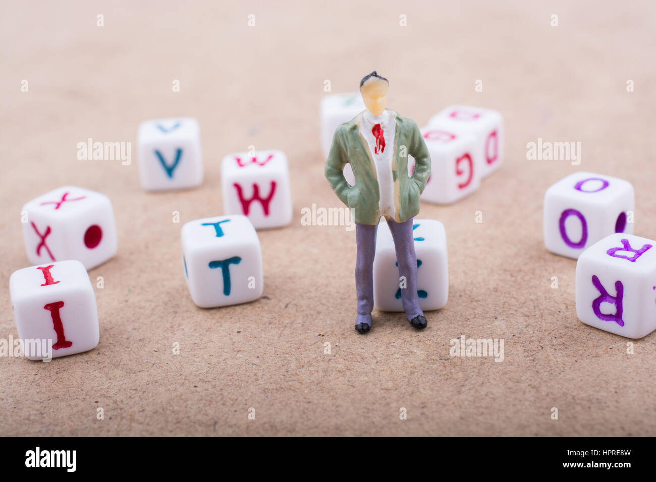 Figurine standing in front of the colorful alphabet letter cubes Stock ...